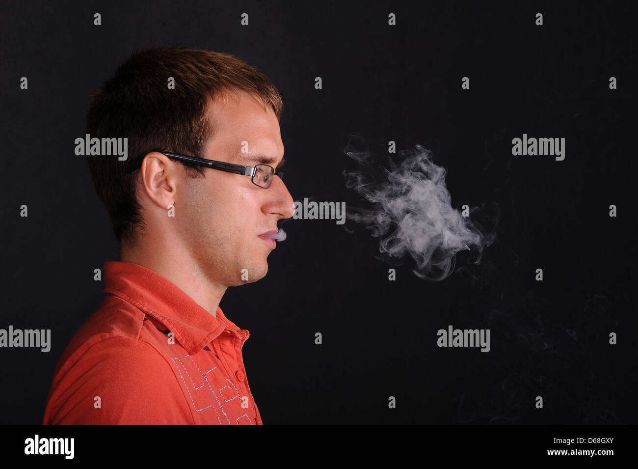 Man blowing smoke Stock Photo - Alamy
