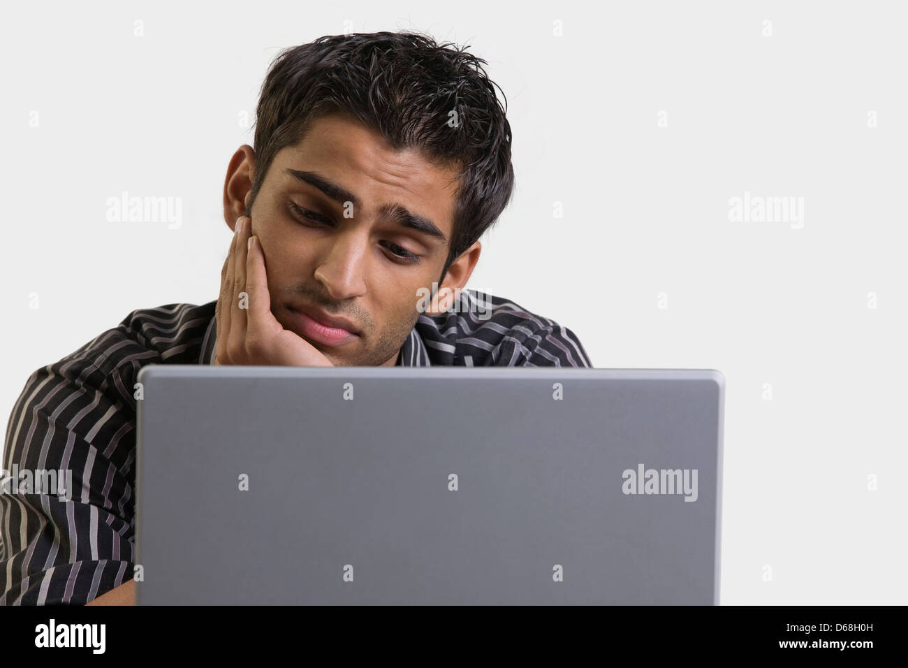 Man tensed while working on laptop Stock Photo - Alamy