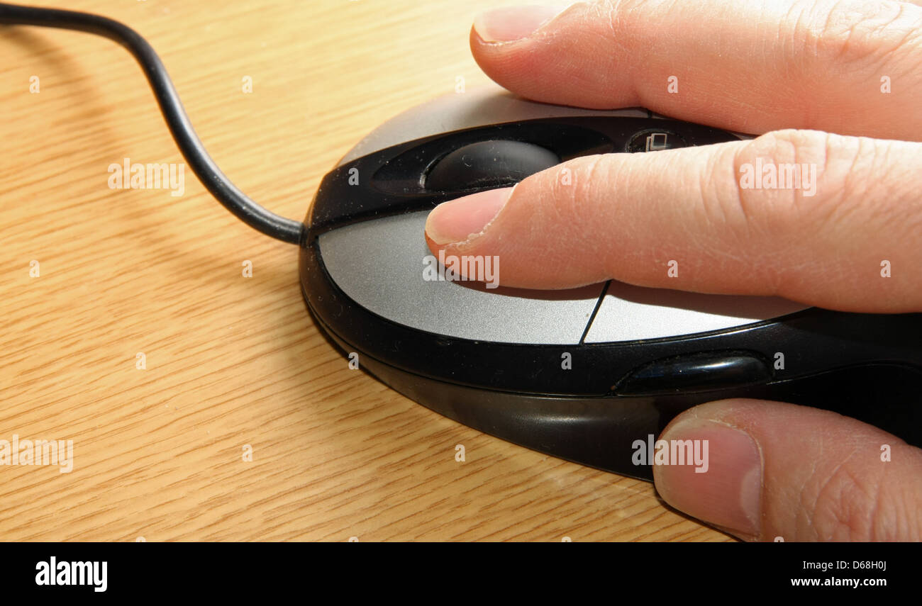 hand of a young adult who click the left mouse button with the index ...