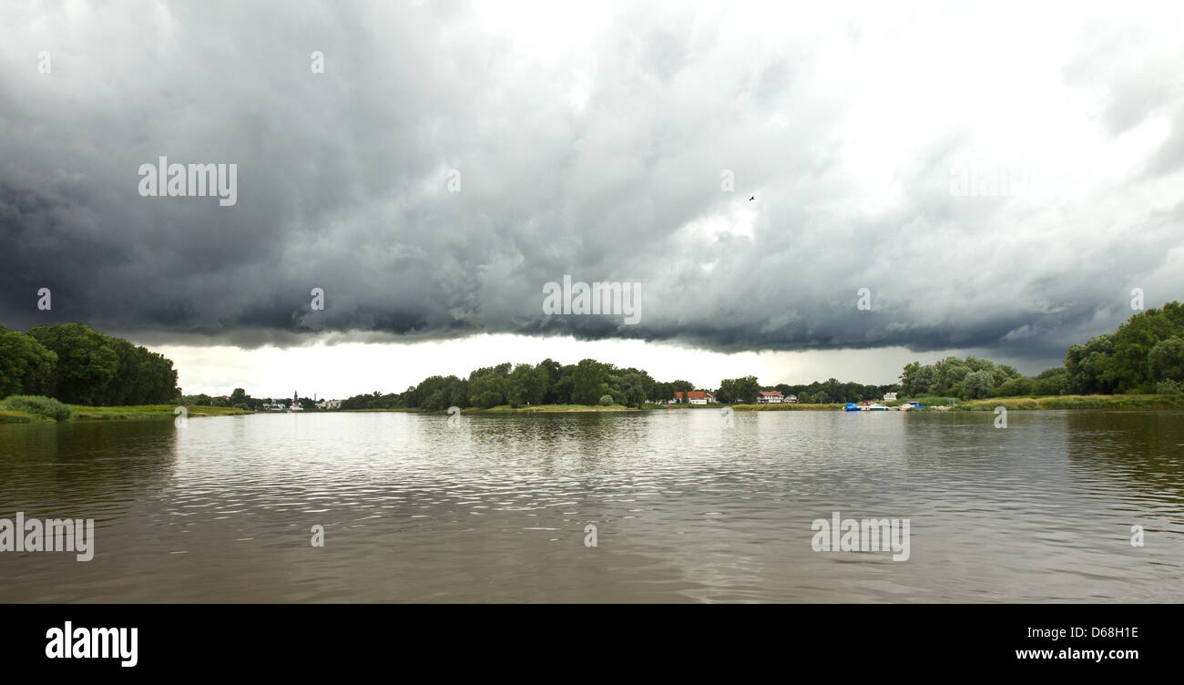 Dark clouds appear above the city of Magdeburg at the Elbe river, Germany, 13 July 2012. Rainy ...