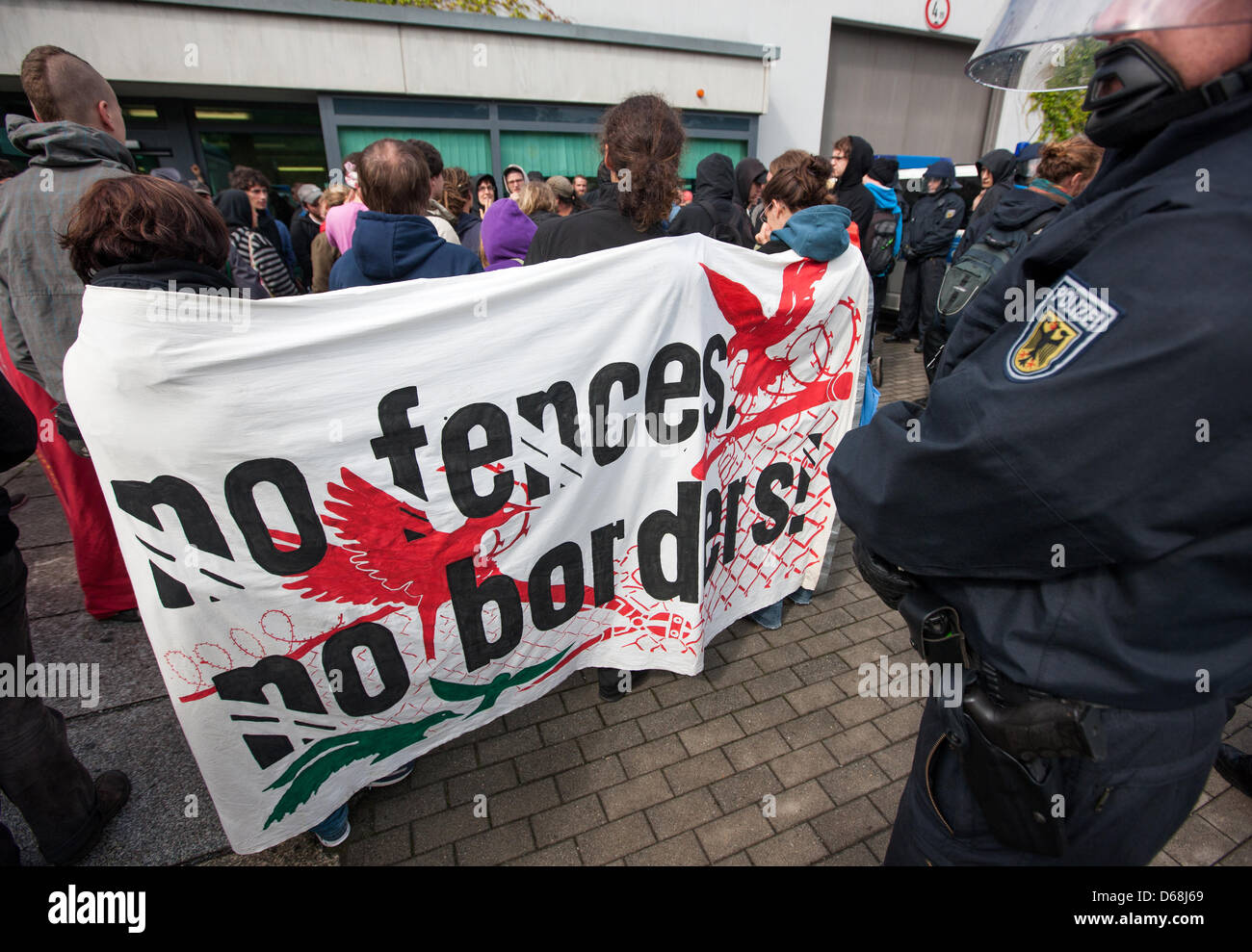 Demonstrators hold a banner saying 'No Fences - no borders' as they ...