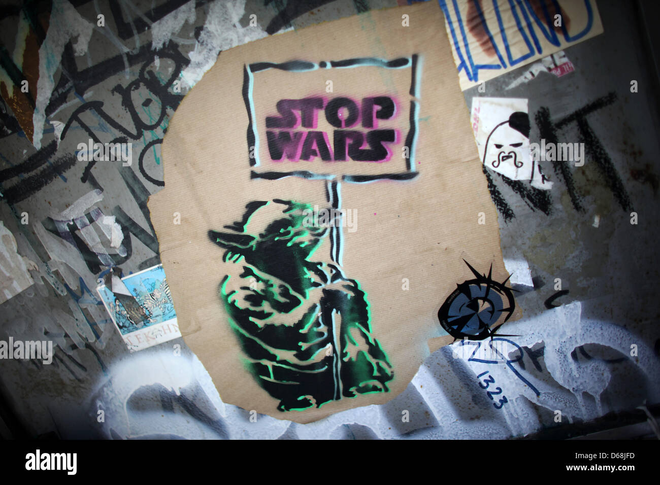 A Graffiti shows Star Wars character Yoda holding up a sign that says ...