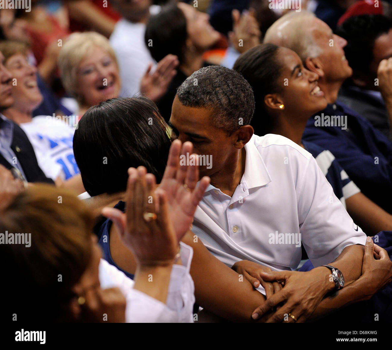 United States President Barack Obama kisses First Lady Michelle Obama ...
