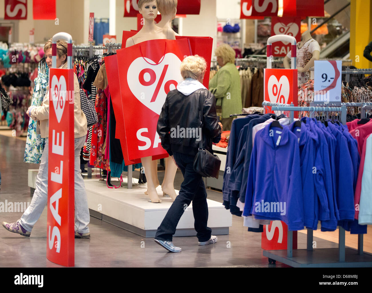 Sale signs decorate a department store in Berlin, Germany, 18 July 2012 ...