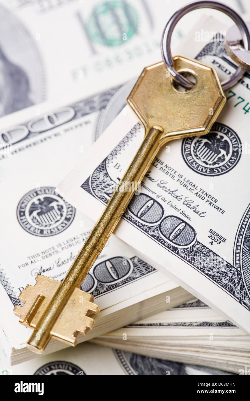 Gold key and money Stock Photo - Alamy