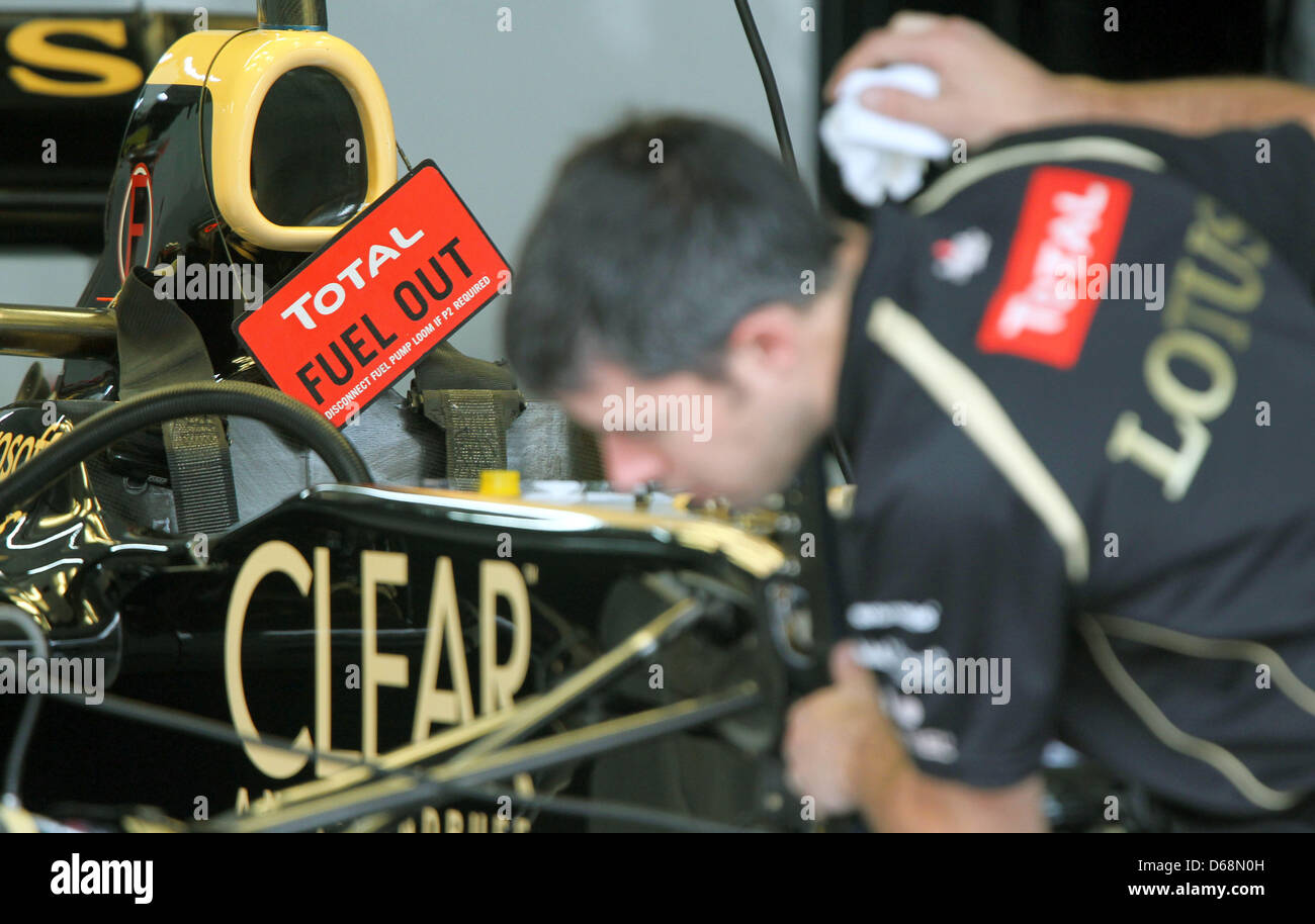 A mechanic of Lotus team works in the pit at Hockenheimring race track ...