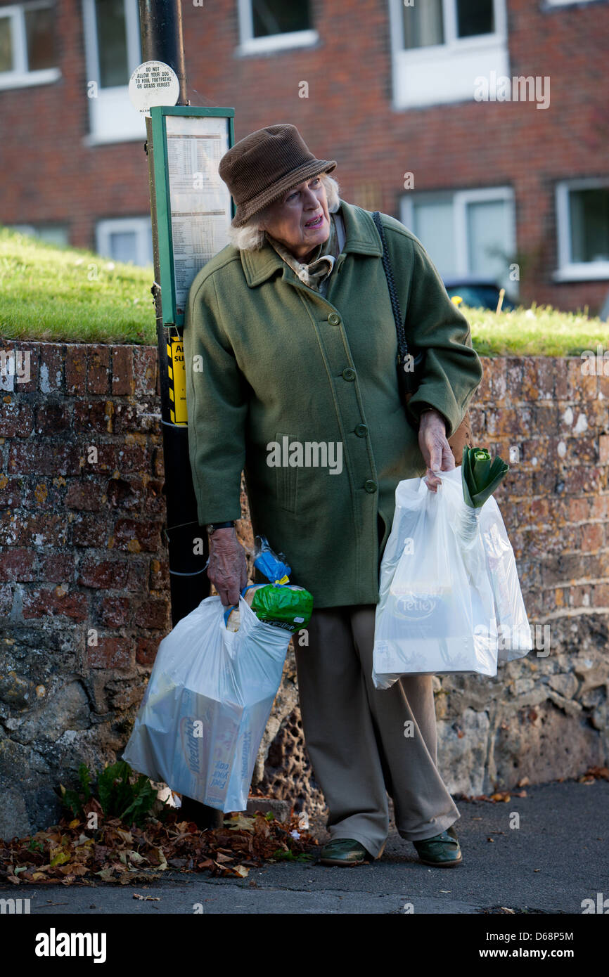 Elderly woman wait bus stop hi-res stock photography and images - Alamy