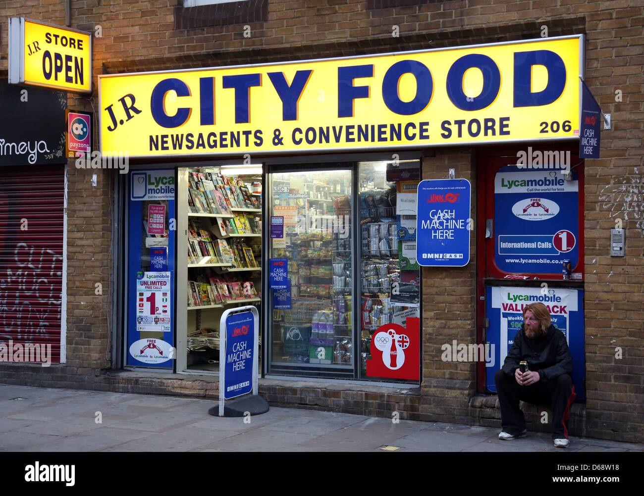 A sign reading "City Food" is seen over the entrance of a convenience ...
