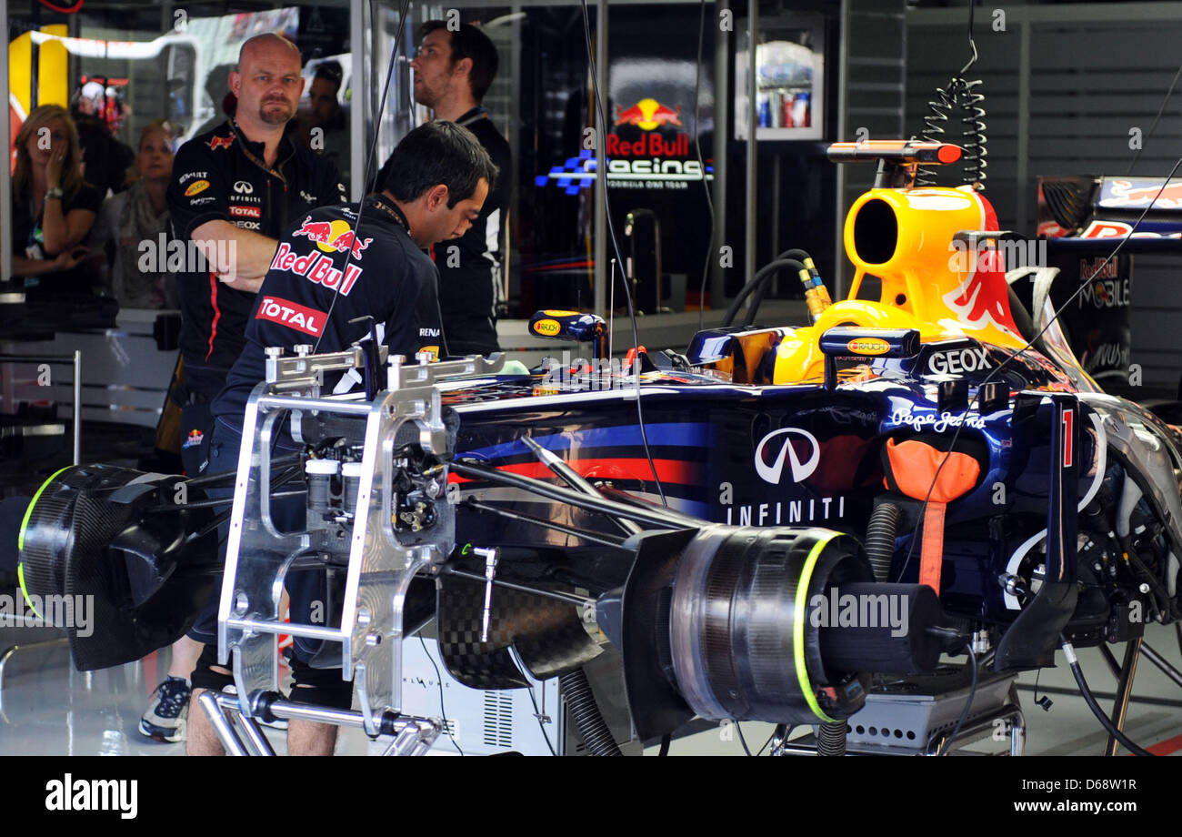 A mechanic of the Red Bull team works in the pit at the at the ...