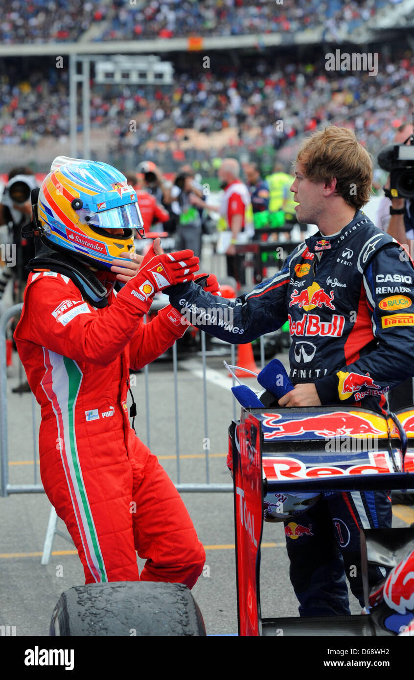 Spanish Formula One driver Fernando Alonso (L) of Ferrari celebrates ...