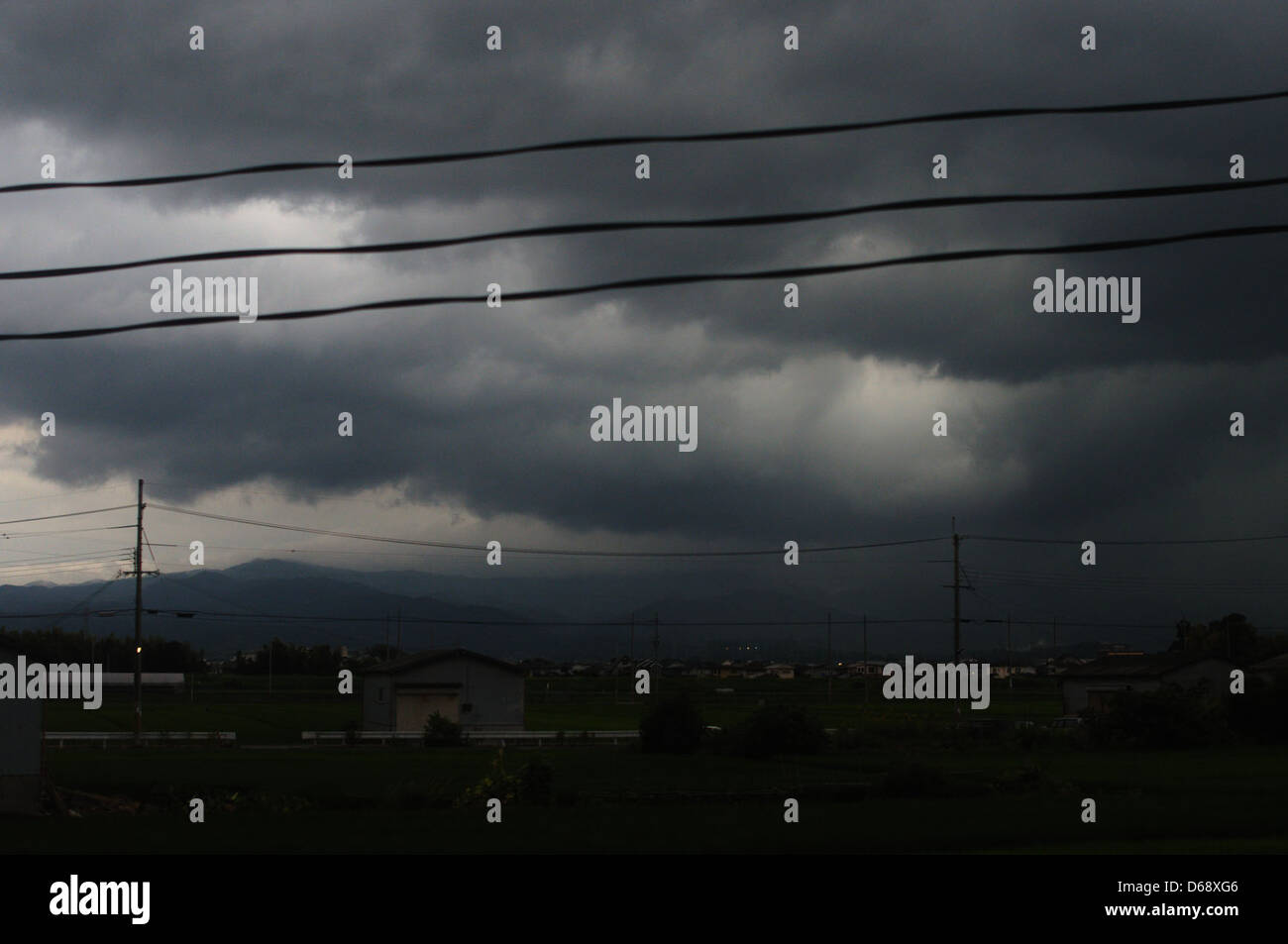 Rainclouds forming over the horizon as a train heads towards Nara ...
