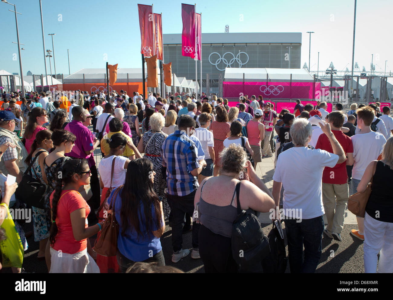 Spectators walk to the Olympic Stadium to watch the rehearsal for the ...