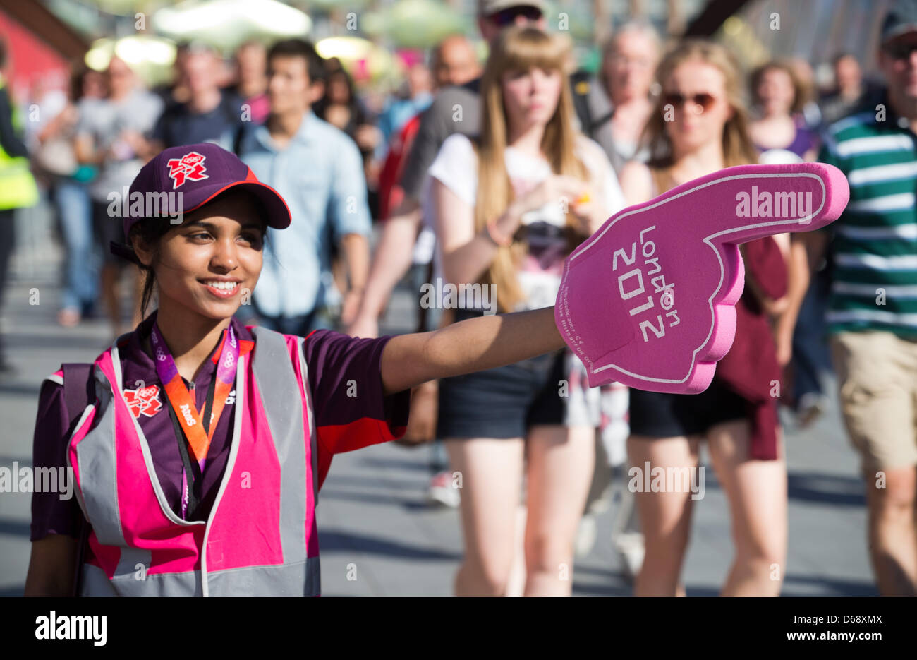 A volunteer directs spectators towards the Olympic stadium to watch the ...
