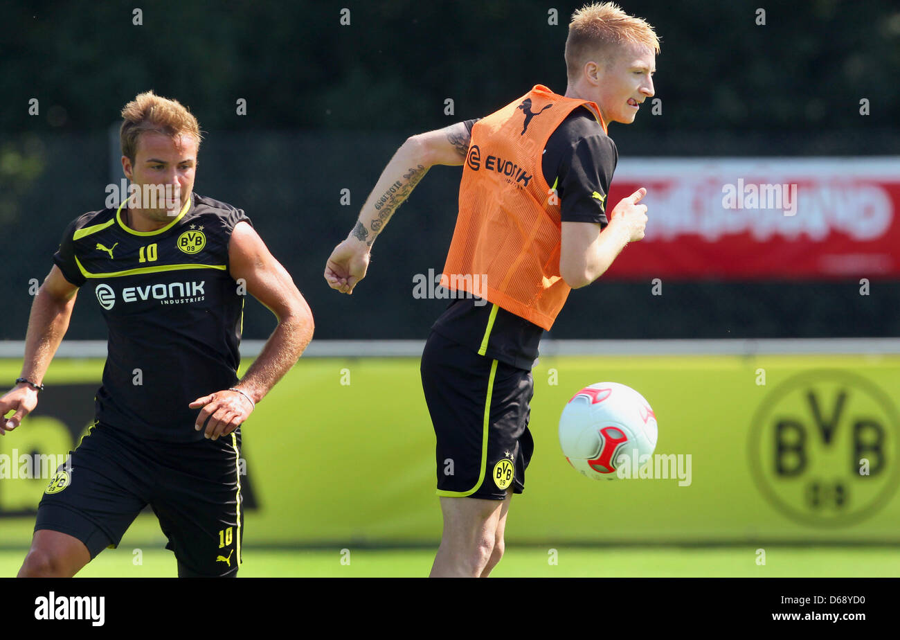 Borussia Dortmund's Marco Reus (R) and Mario Goetze takes part in ...