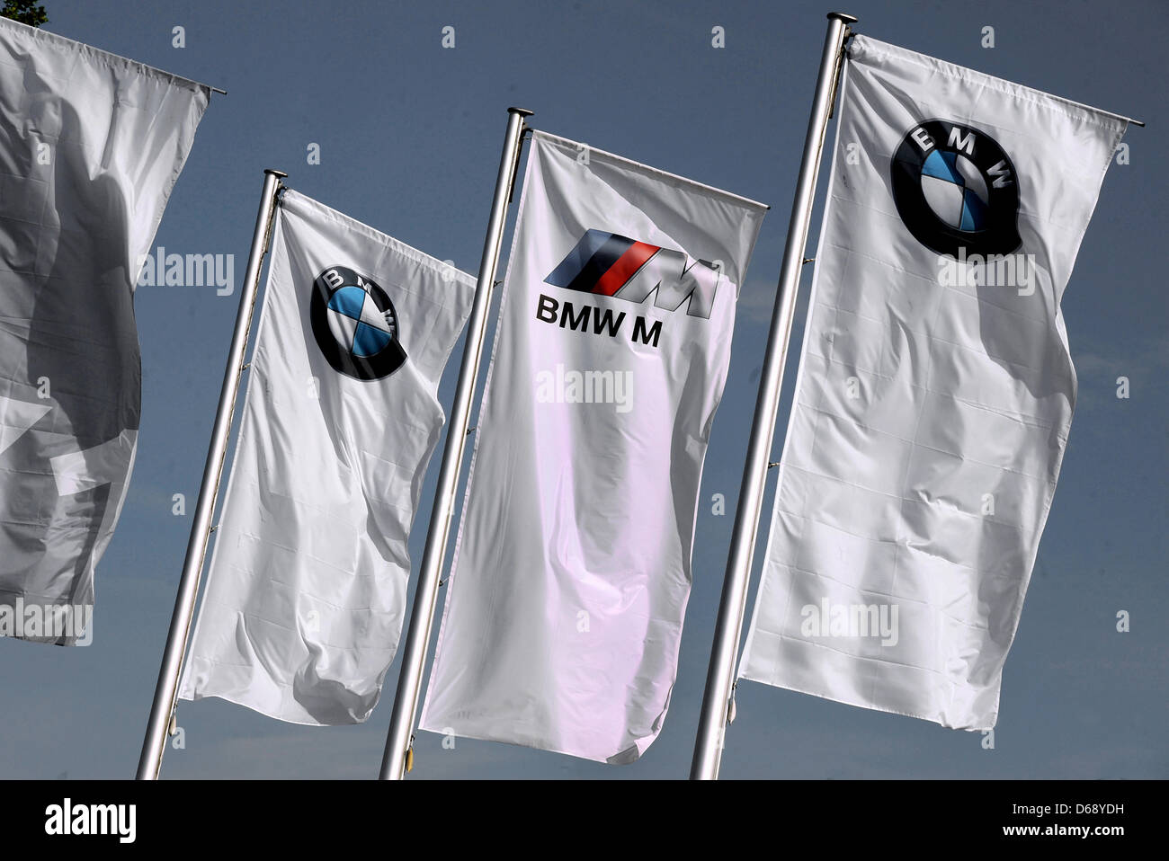 Flags with the company logo wave in front of the BMW factory in Leipzig ...