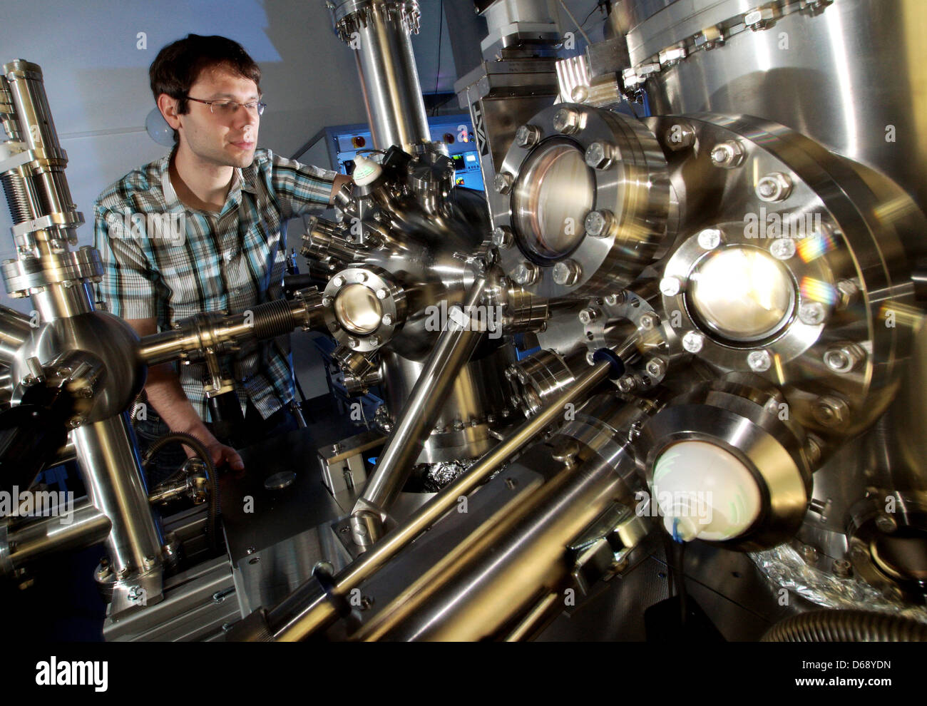 Physicist Dr. Roman Forker works on a modern research device of a ...
