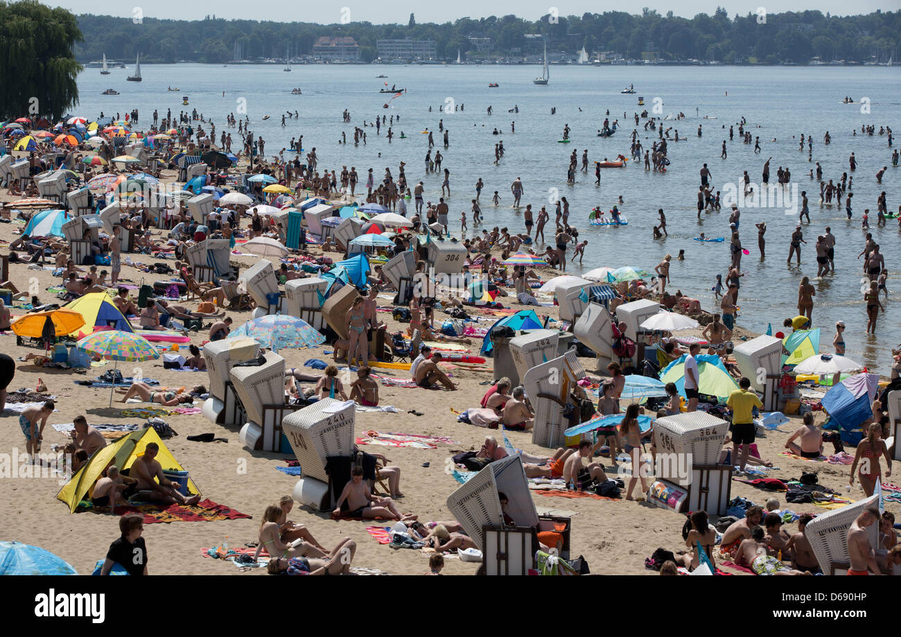 Many people are visiting the beach at Strandbad Wannsee with warm ...