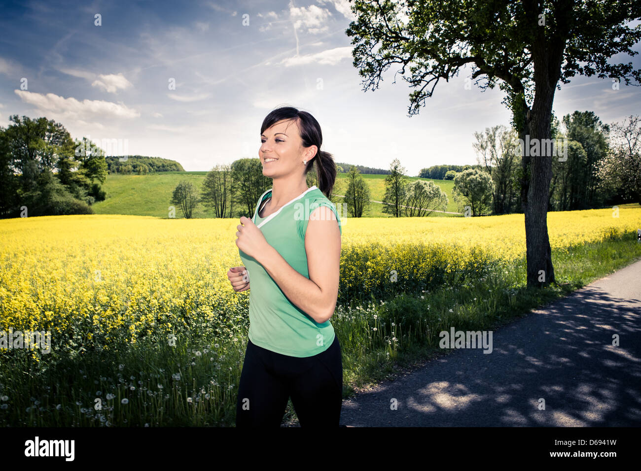 A woman jogging in front of cross country Stock Photo - Alamy