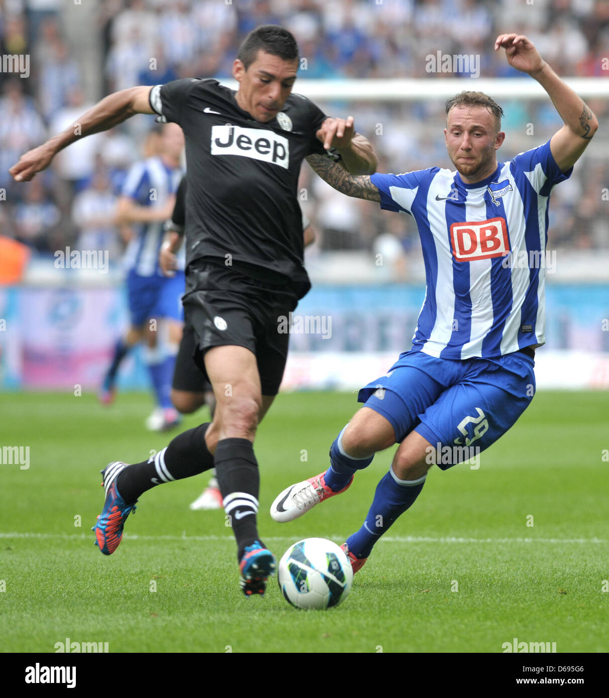 Juventus FC's Lucio (L) vies for the ball with Berlin's Marvin Knoll ...