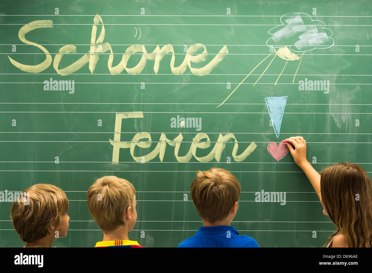 ILLUSTRATION - Third graders write the words 'Schoene Ferien' ('Good ...