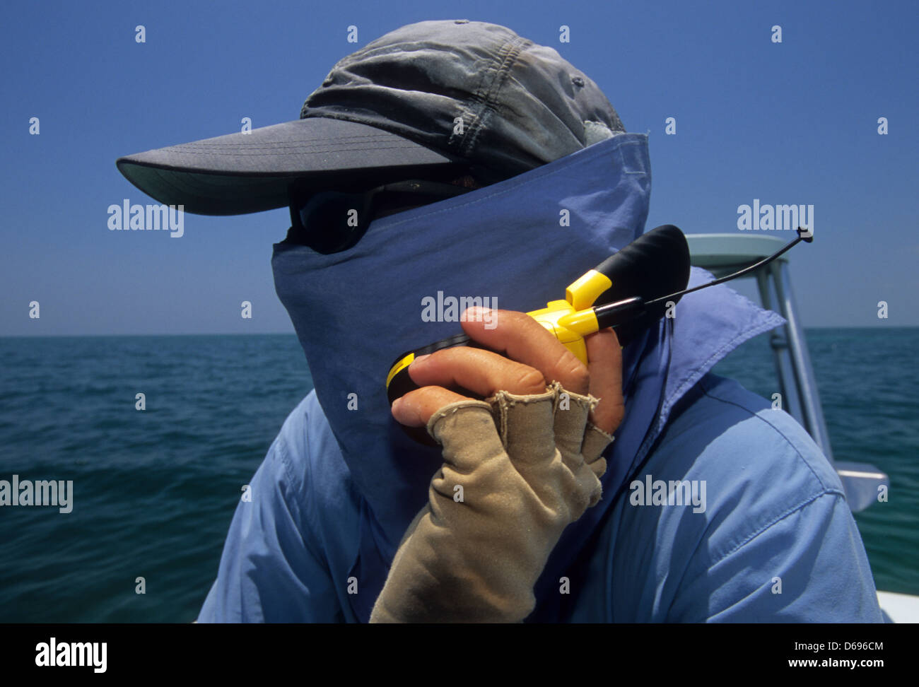 A fishing guide talks on a cell phone at Marathon in the Florida Keys ...