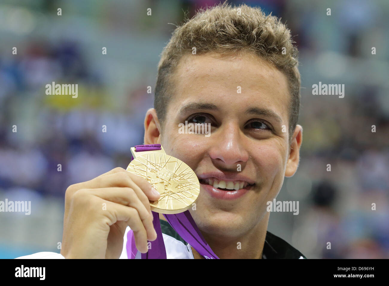 Chad le Clos of South Africa shows his gold medal after the Men's 200m ...