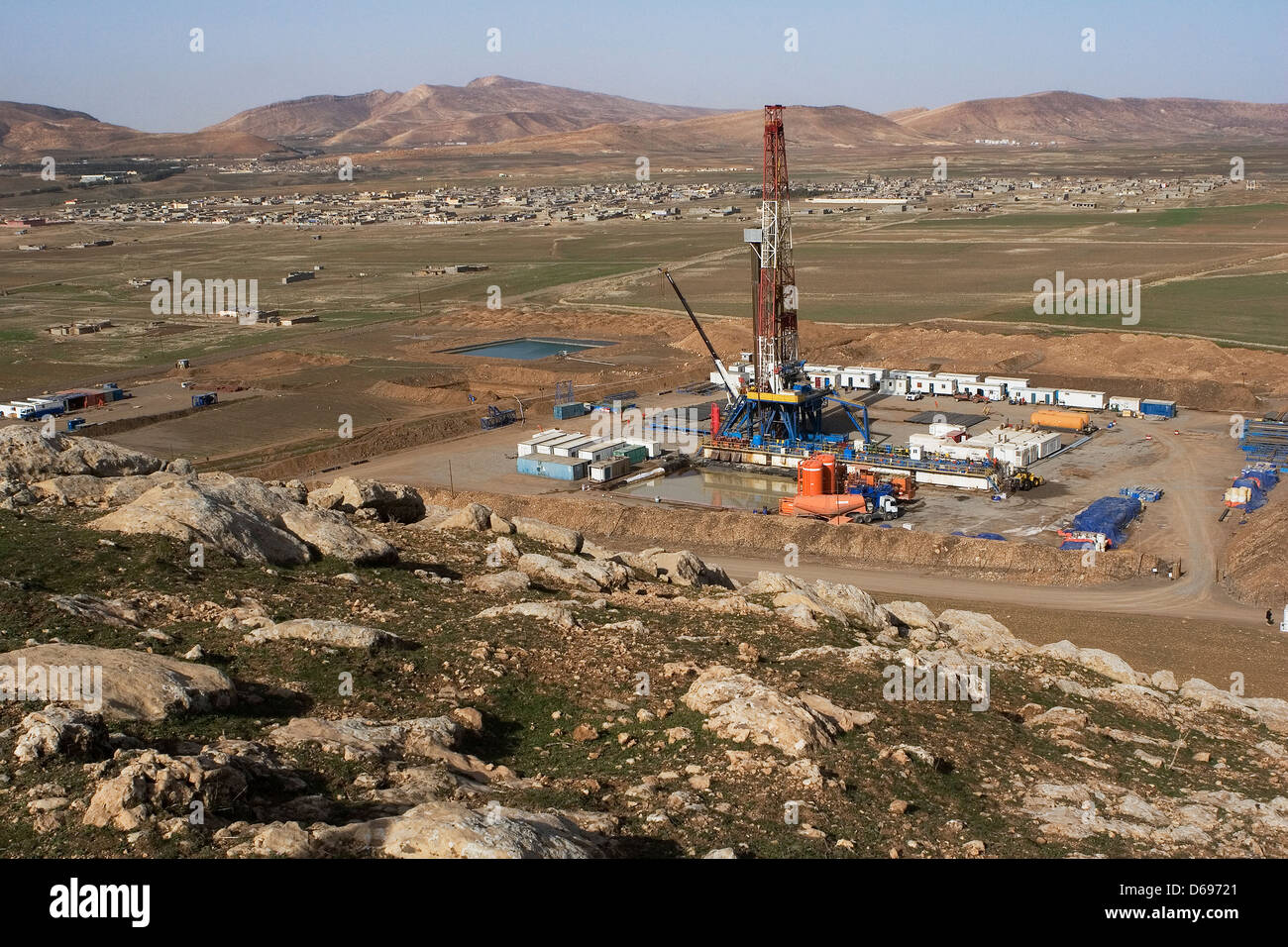 Oil and gas onshore exploration rig site in valley with mountains on ...