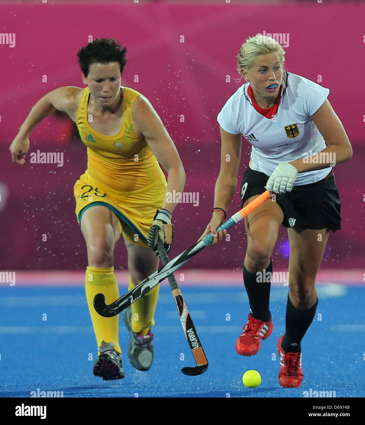 Germany's Jennifer Plass (R) fights for the ball with Australia's ...