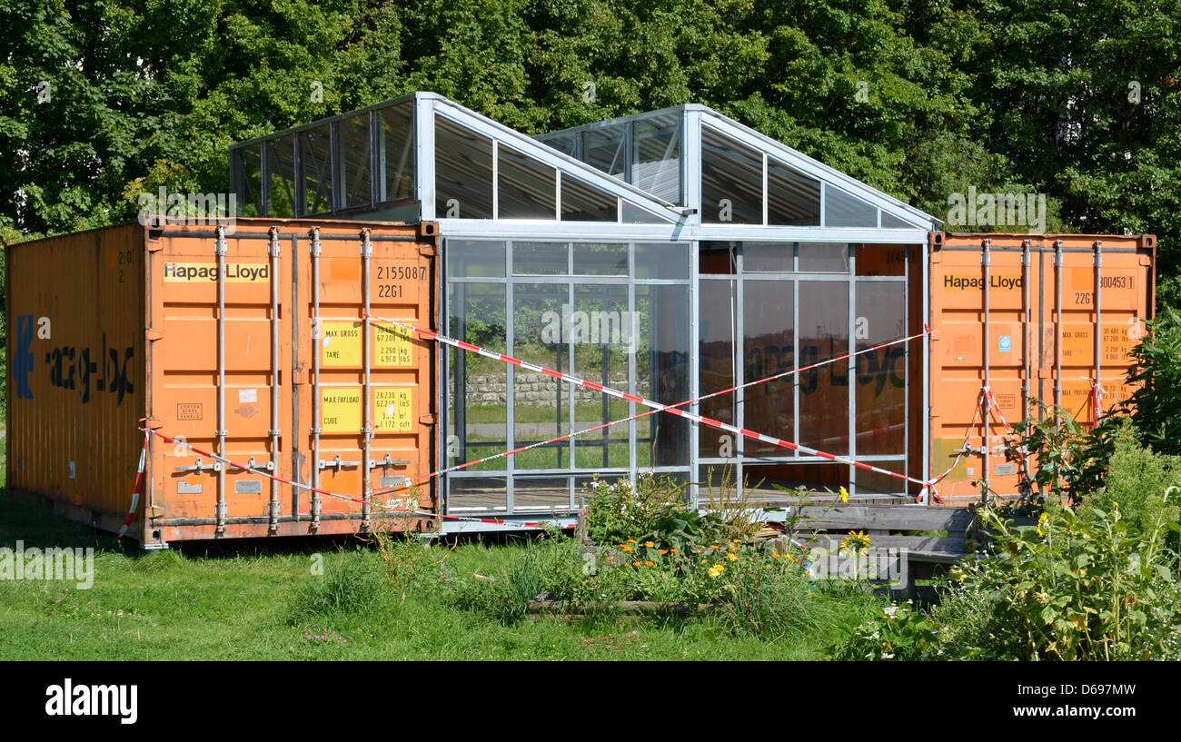 A pavilion made of two old shipping containers and old windows from the ...