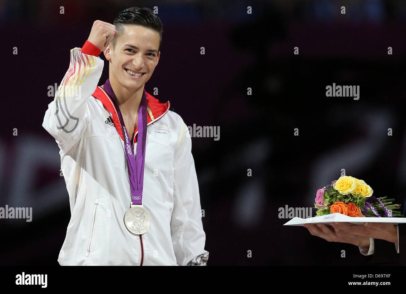 Silver medalist Marcel Nguyen of Germany celebrates on the podium after ...