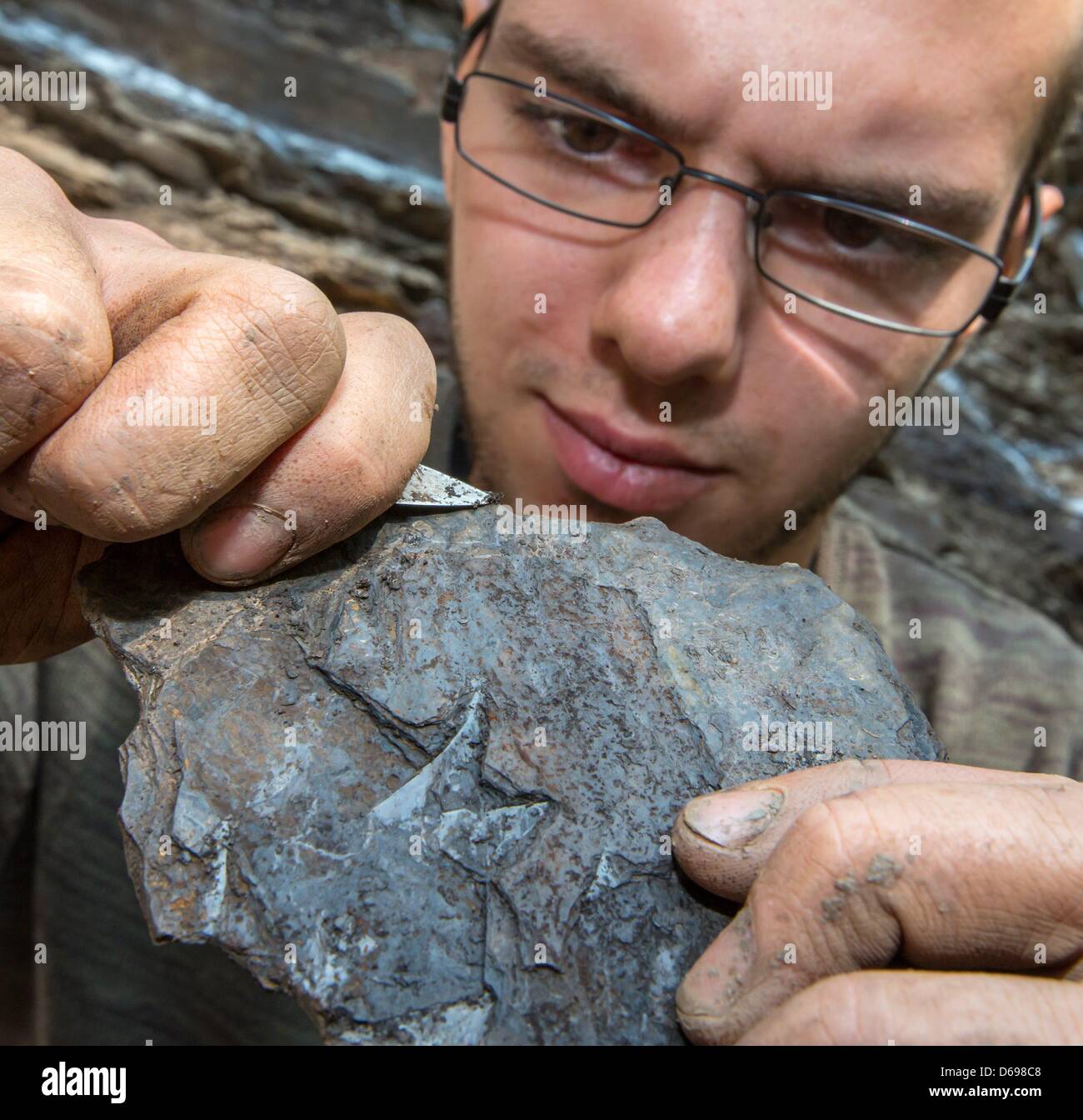 Student of geology at TU Bergakademie Freiberg, Axel Rommel, examines ...
