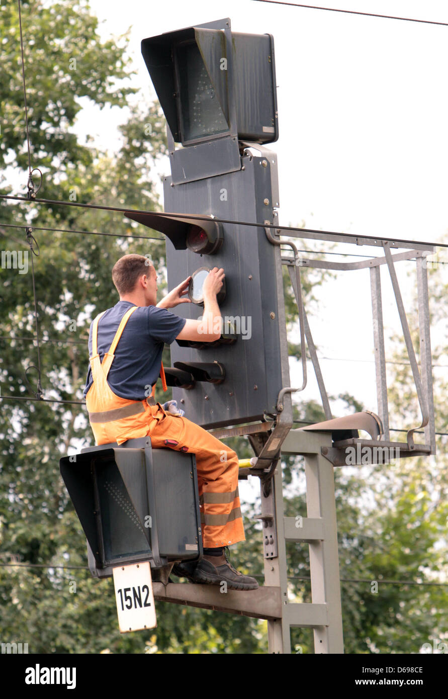 A technician of the German railway company Deutsche Bahn (DB) maintains ...