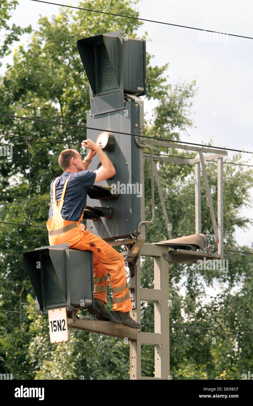 A technician of the German railway company Deutsche Bahn (DB) maintains ...