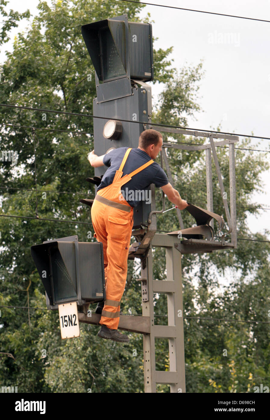 A technician of the German railway company Deutsche Bahn (DB) maintains ...