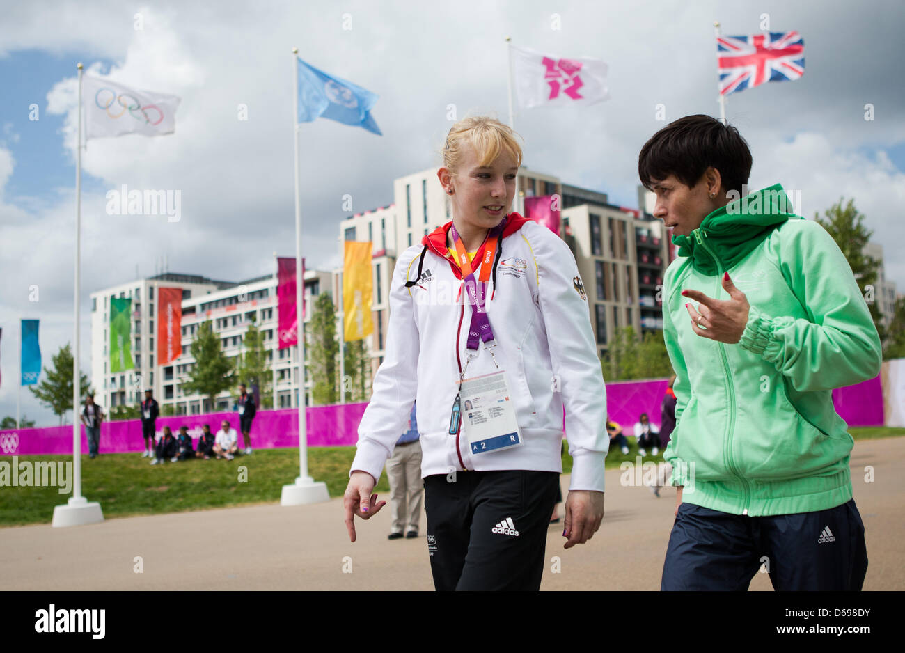 Germany's gymnasts Oksana Chusovitina (l) and Janine Berger walk ...