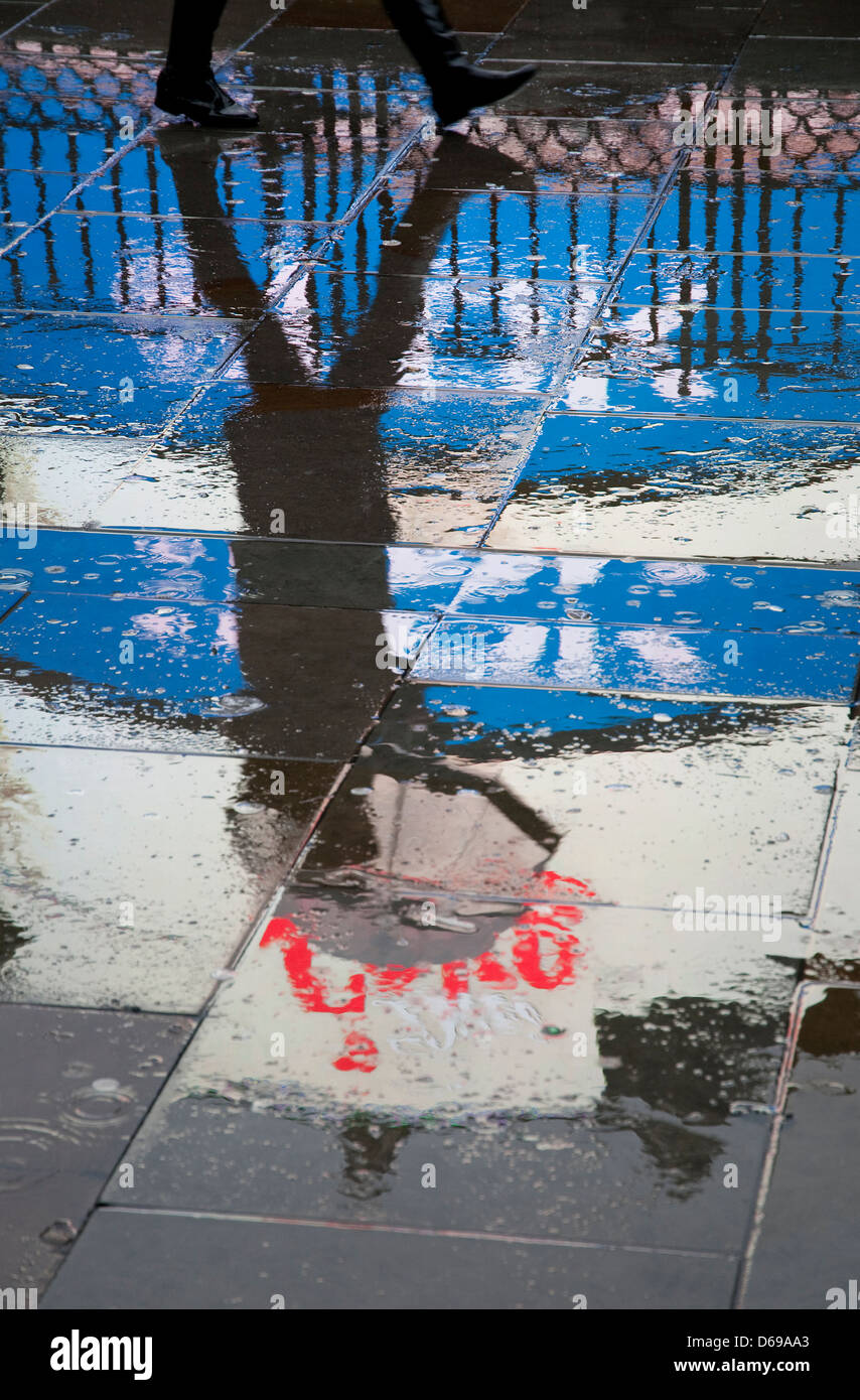 neon sign reflections on wet pavement, piccadilly circus, london ...