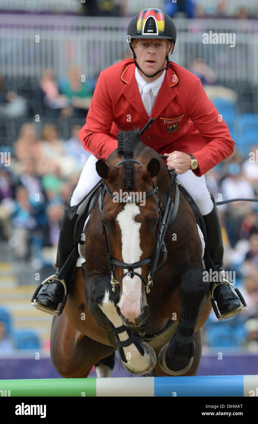 German jumping rider Marcus Ehning jumps with his horse Plot Blue an ...