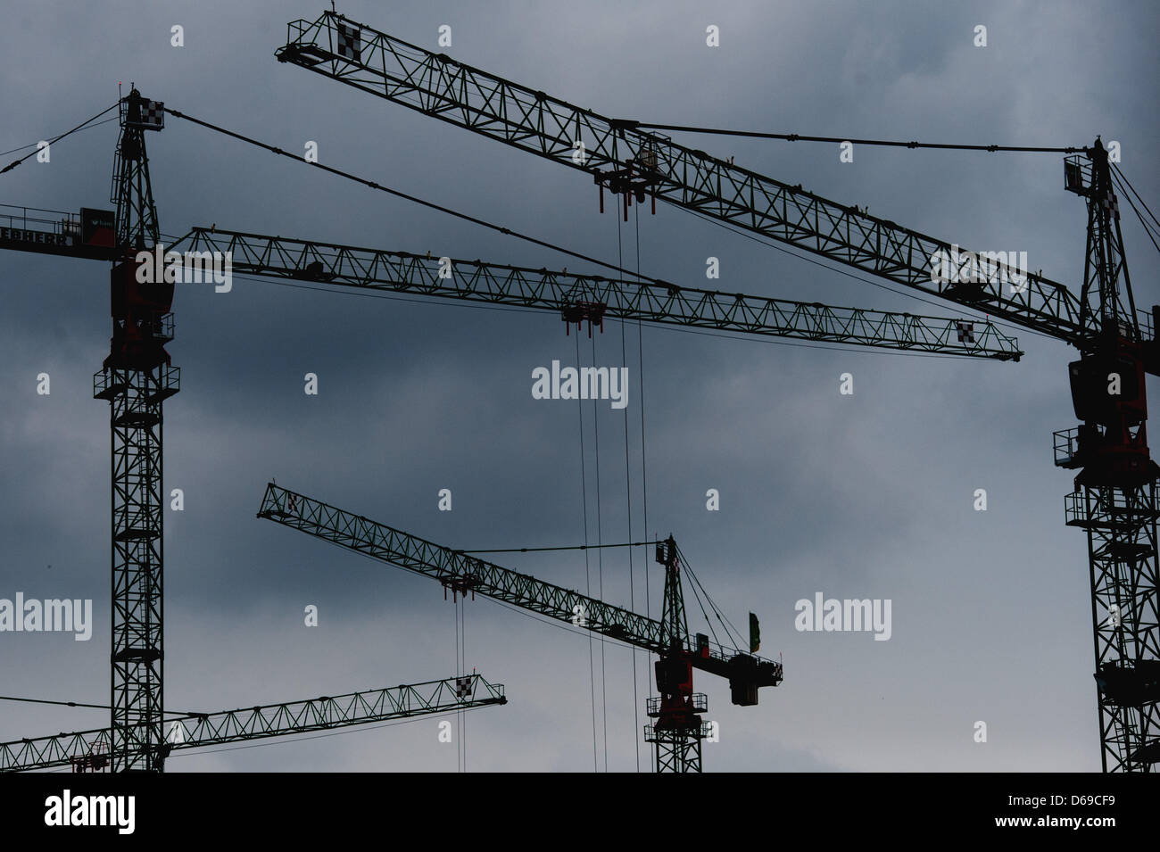 Dark rain clouds move across cranes in Berlin, Germany, 06 August 2012 ...