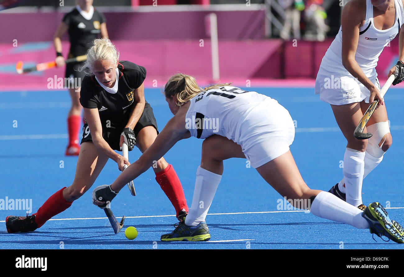 Jennifer Plass (L) of Germany fights for the ball against Clarissa ...