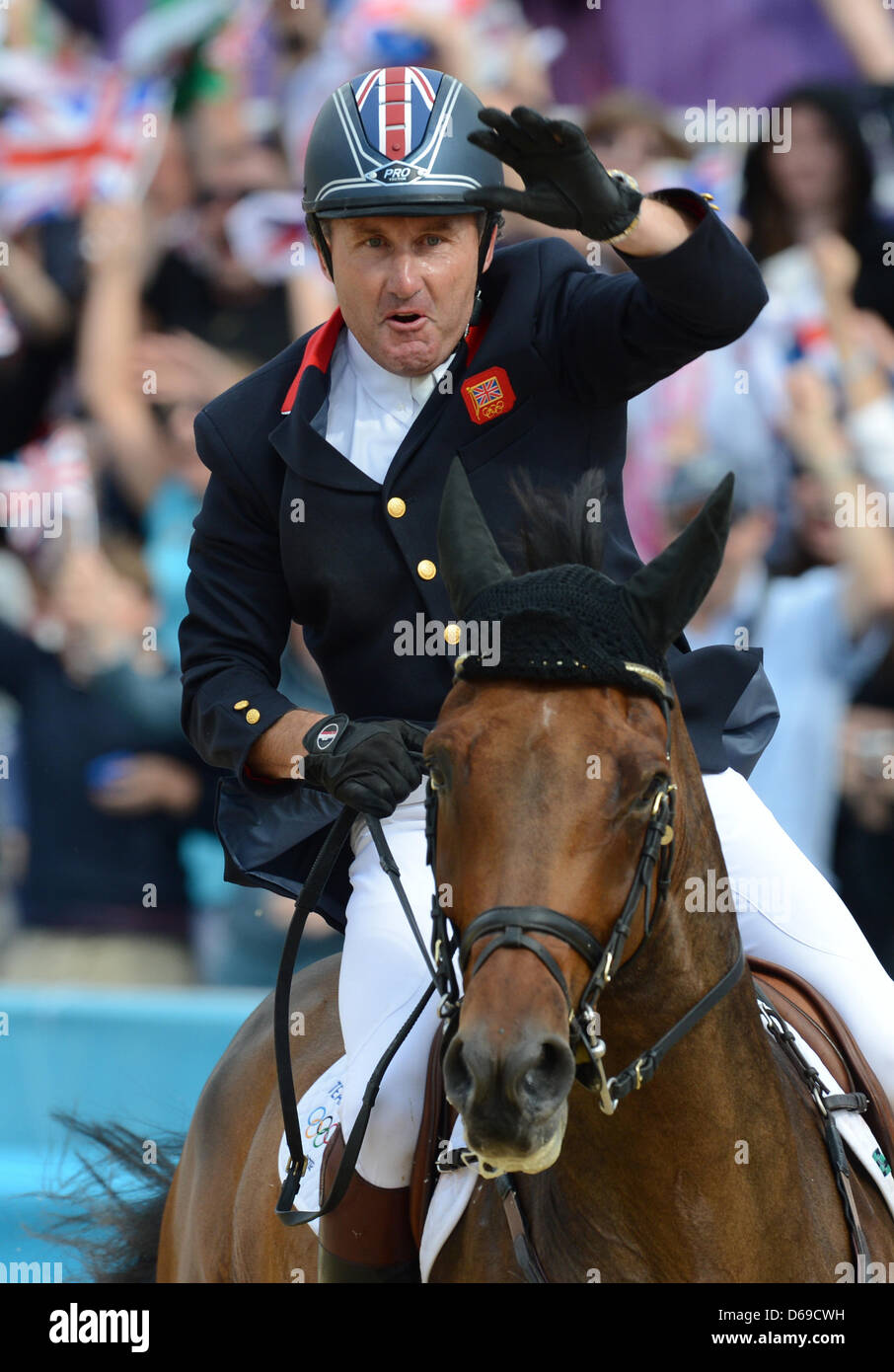 British jumping rider Peter Charles cheers after winning gold with the ...