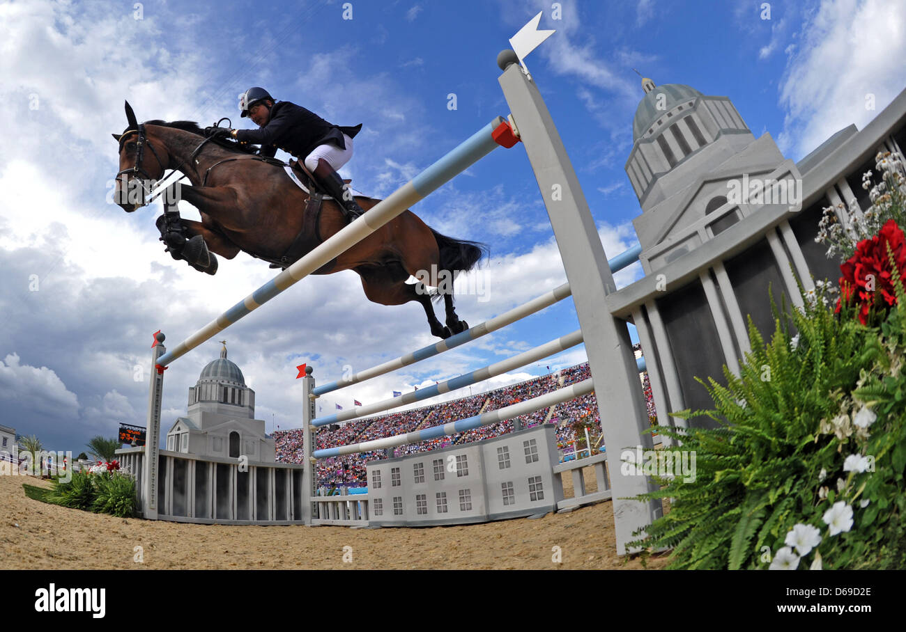 British jumping rider Peter Charles jumps on his horse Vindicat a fence ...