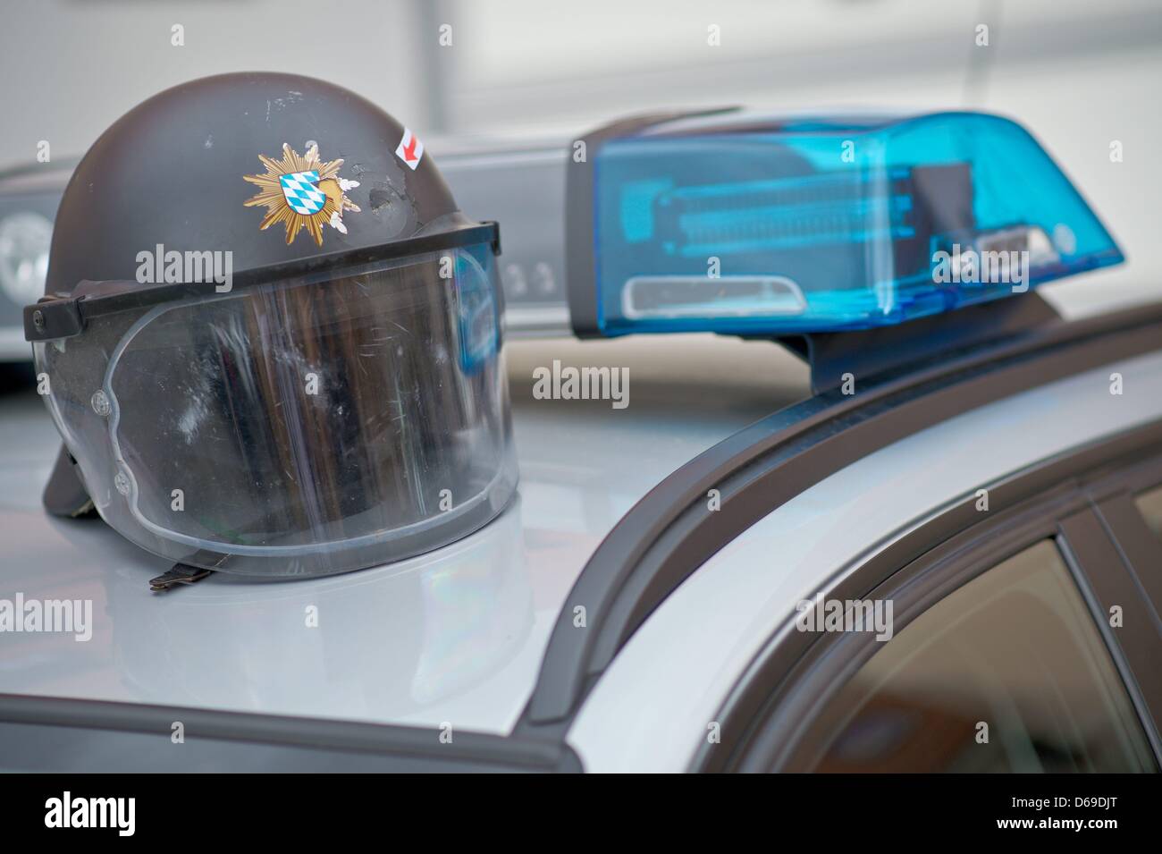 A police helmet damaged by stone throwers sits on the roof of a police ...