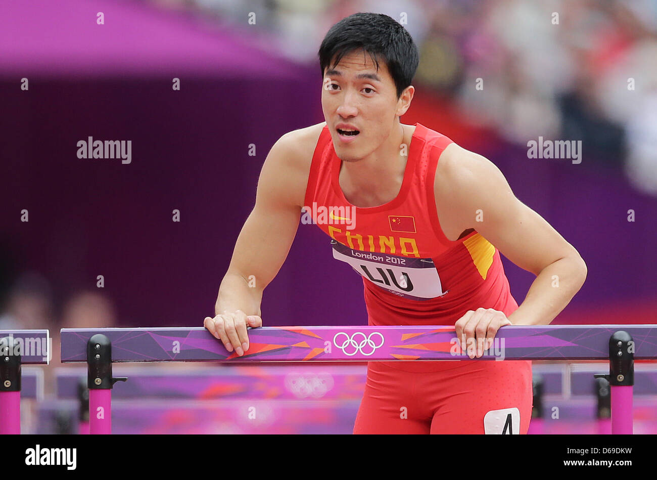 China's Xiang Liu leaves the track, after get injured during the 110m ...