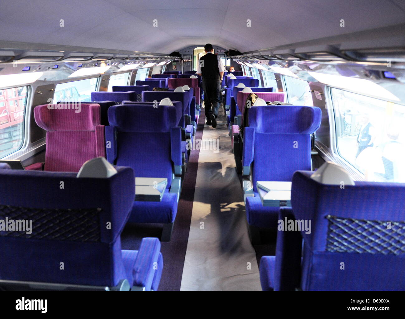 A staff member walks through a compartment of the double-decker TGV ...