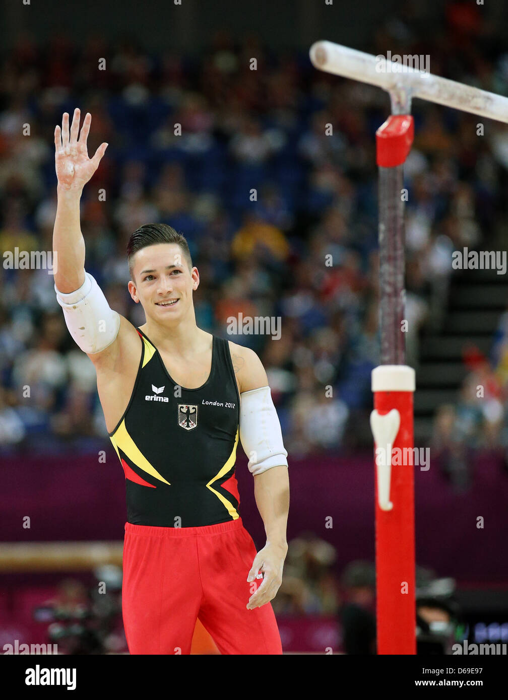 Germany's Marcel Nguyen cheers after performing in the Men's Parallel ...