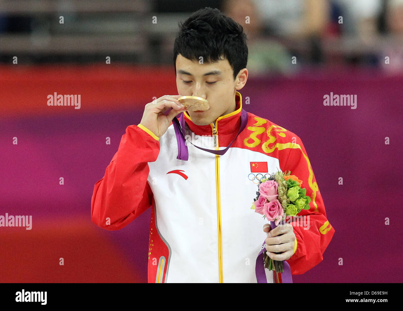 Gold medal winner Zhe Feng of China kisses his medal after the Men's ...