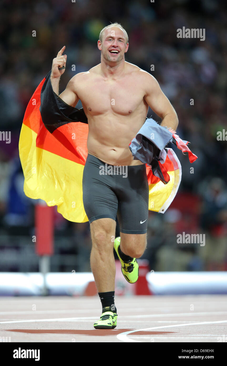 Robert Harting of Germany celebrates after winning the Men's Discus ...