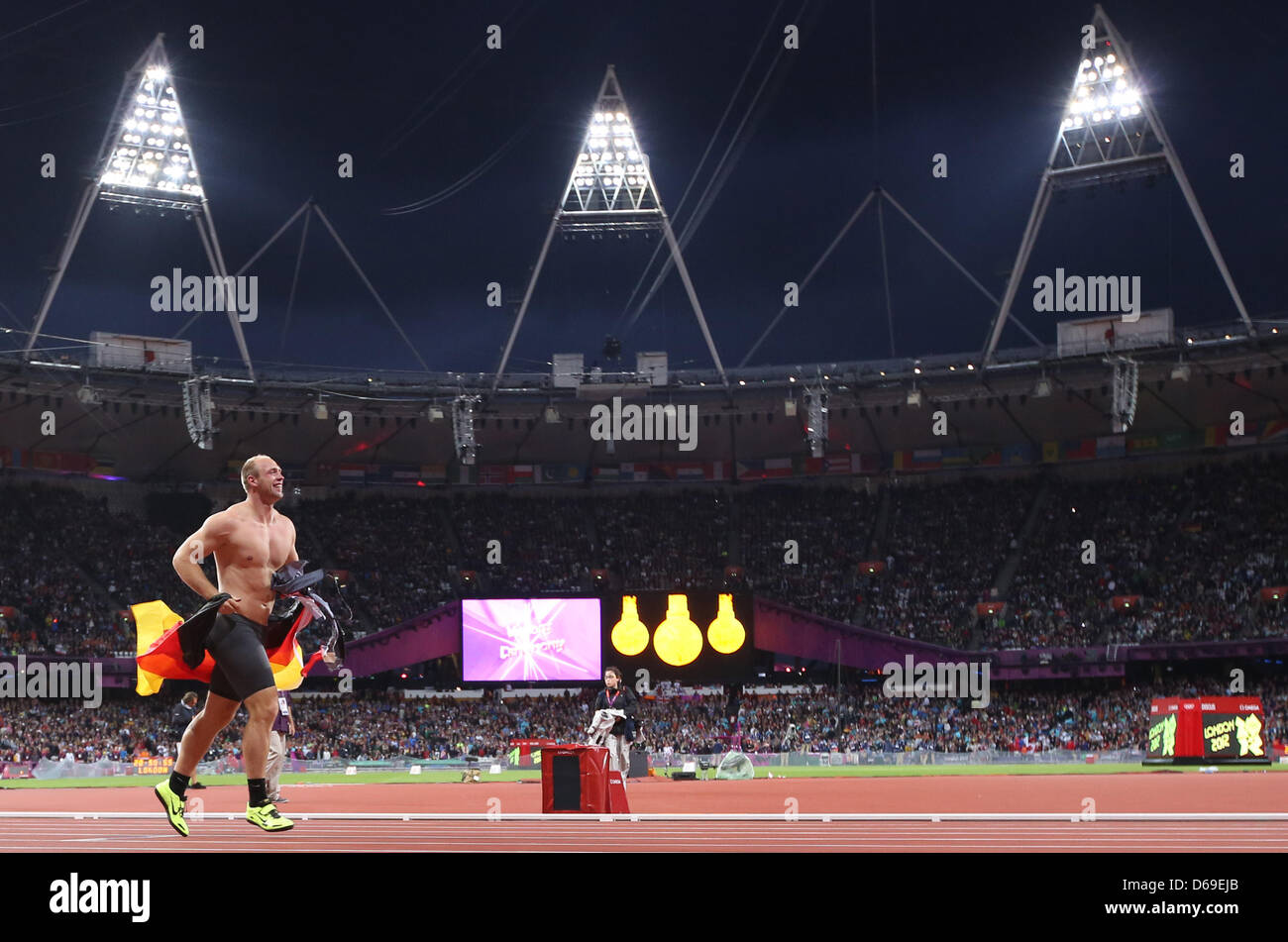 Robert Harting of Germany celebrates after winning the Men's Discus ...