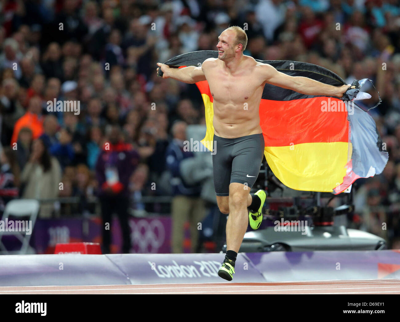 Robert Harting of Germany celebrates after winning the Men's Discus ...