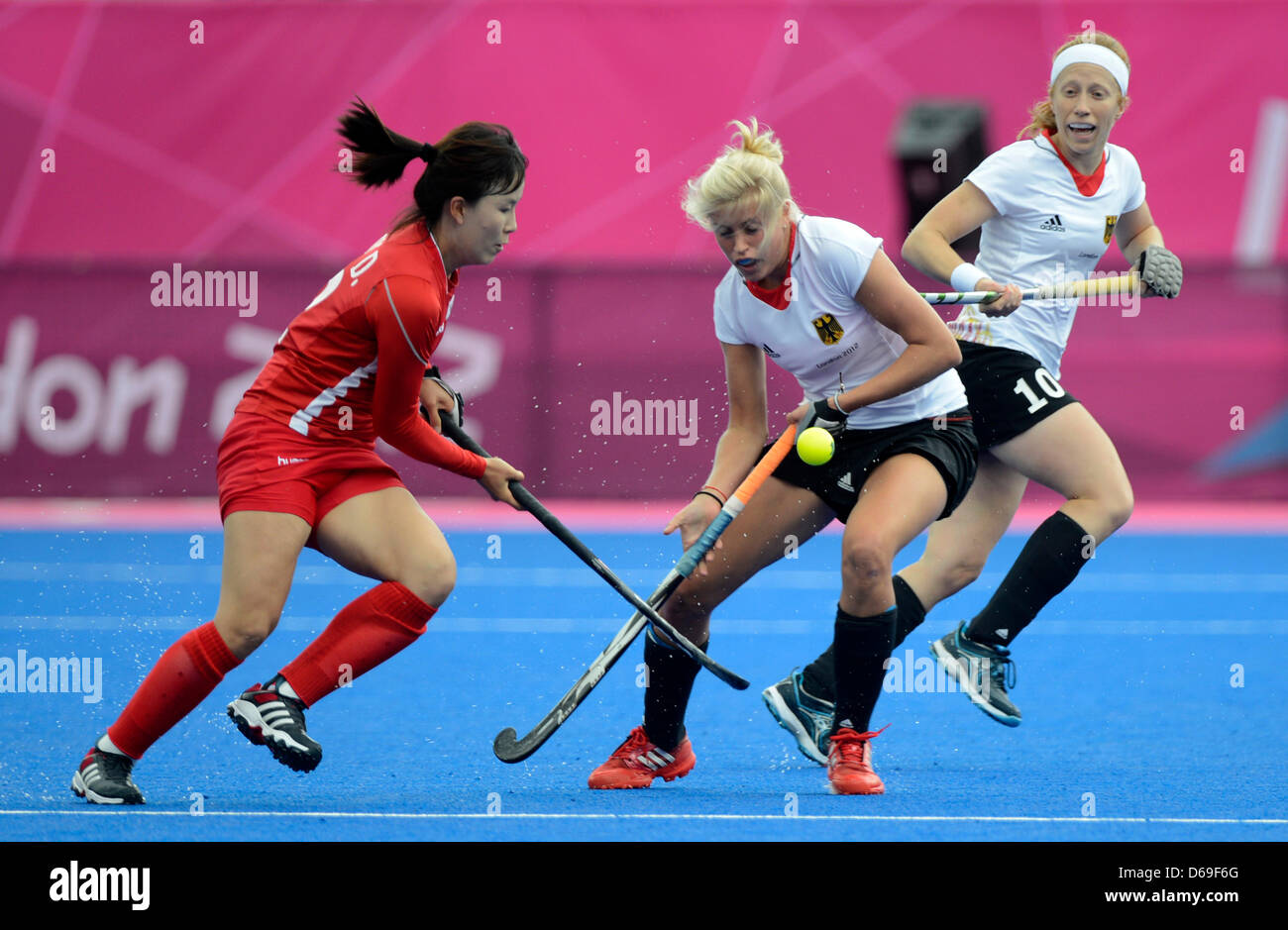 Darae Kim (L) of Korea fight for the ball with Kristina Hillmann (C) of ...